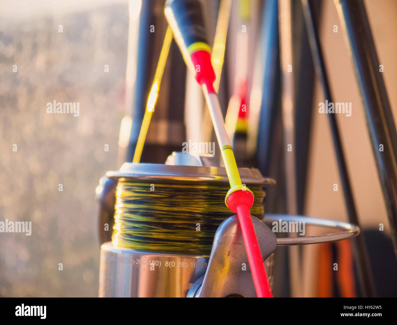 The bright float, fishing rod and fishing reel close-up Stock Photo - Alamy
