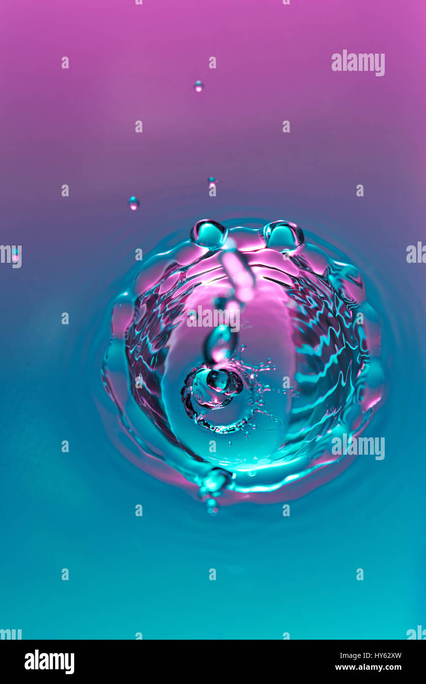 Crystal clear colorful water splash on smooth calm liquid surface Stock ...