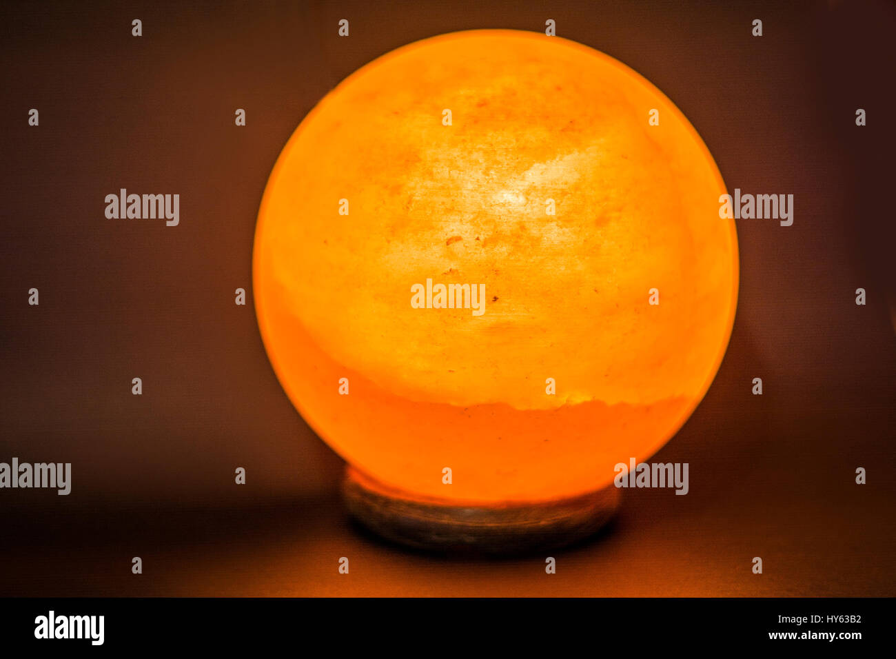 Glowing round red salt lamp Stock Photo - Alamy