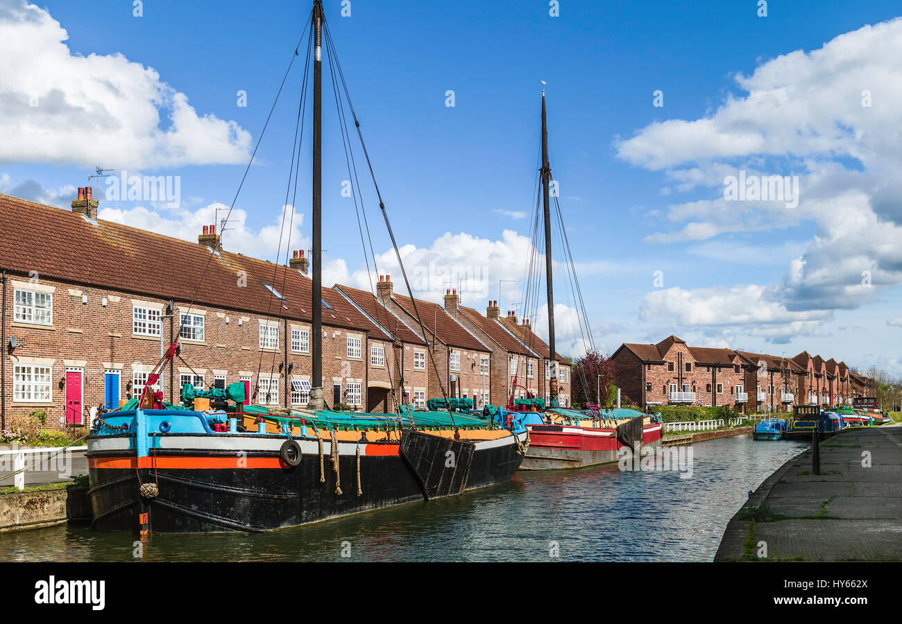 Restored barges anchored on the beck (canal) surrounded by modern ...