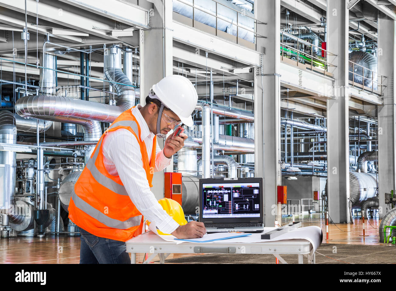 Electrical engineer working at control room of a modern thermal power ...