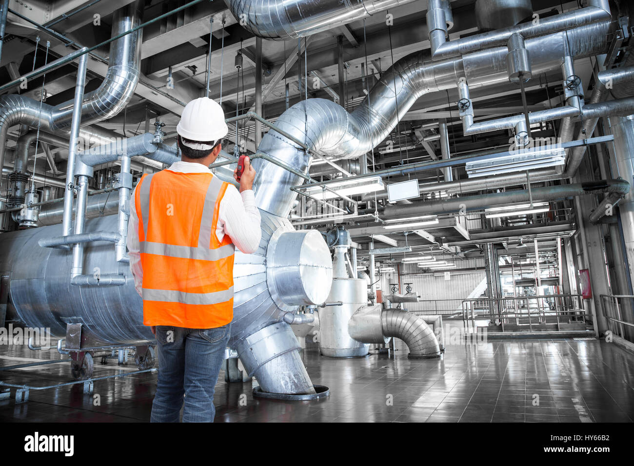 Engineer working in a thermal power plant with talking on the walkie ...