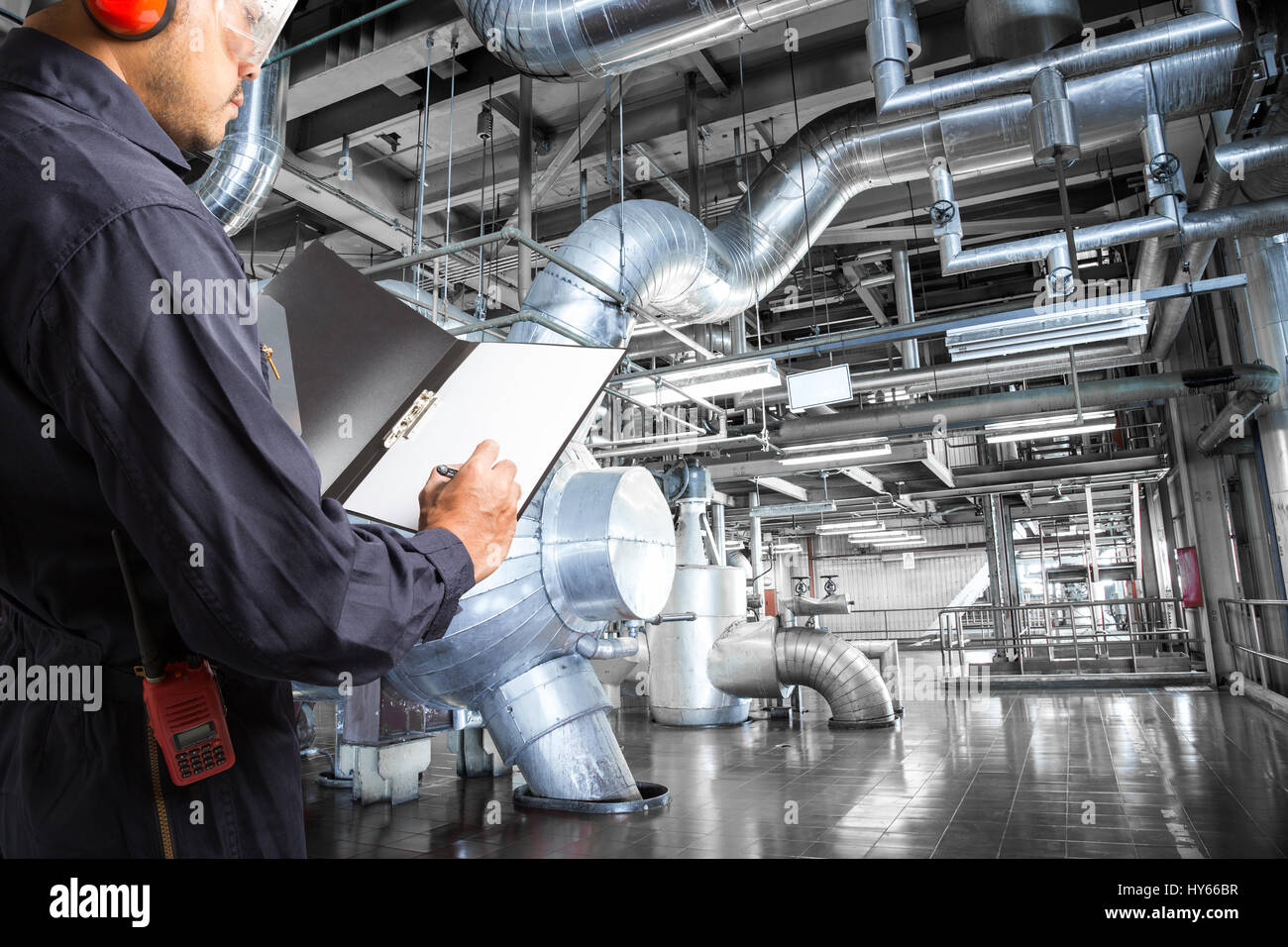 Engineer taking notes at thermal power plant factory Stock Photo - Alamy