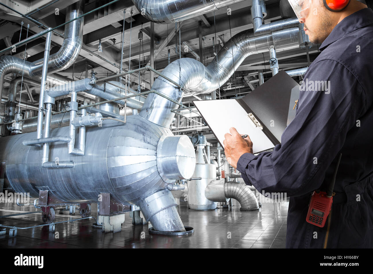 Engineer taking notes at thermal power plant factory Stock Photo - Alamy
