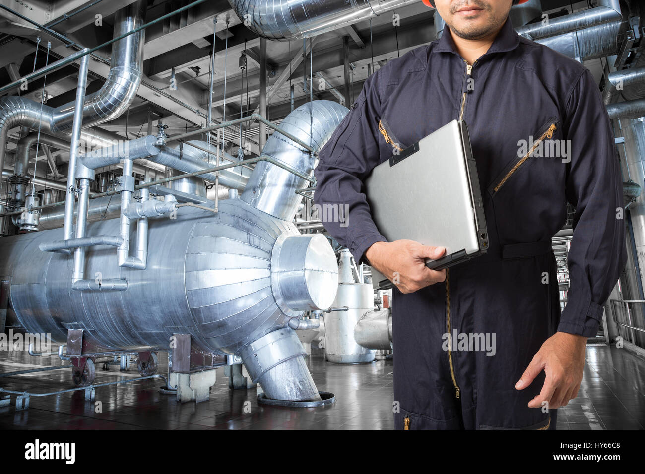 Engineer using laptop computer in the factory Stock Photo - Alamy