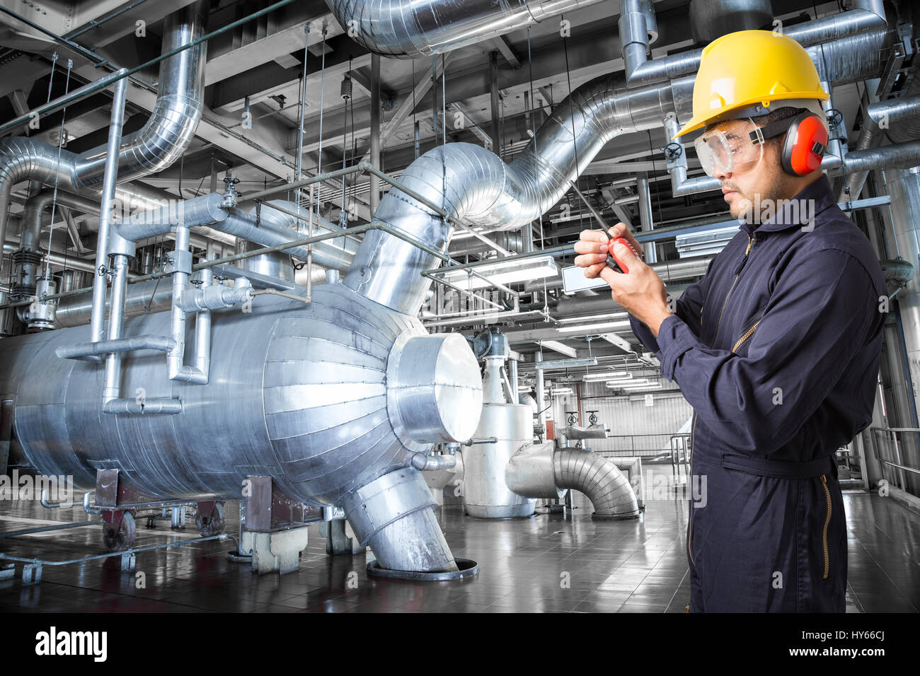 Engineer working in a thermal power plant with talking on the walkie ...