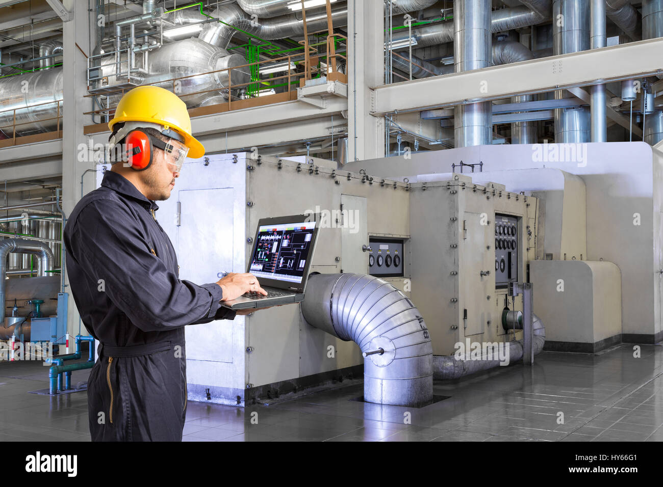 Engineer using laptop computer for maintenance equipment in thermal ...