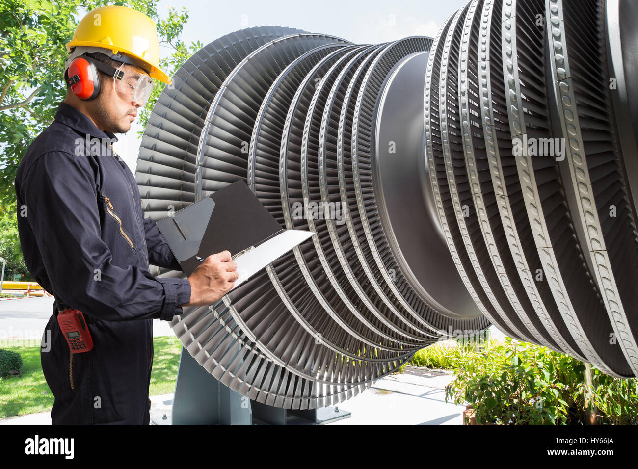 Engineer taking notes for maintenance steam turbine of thermal power ...