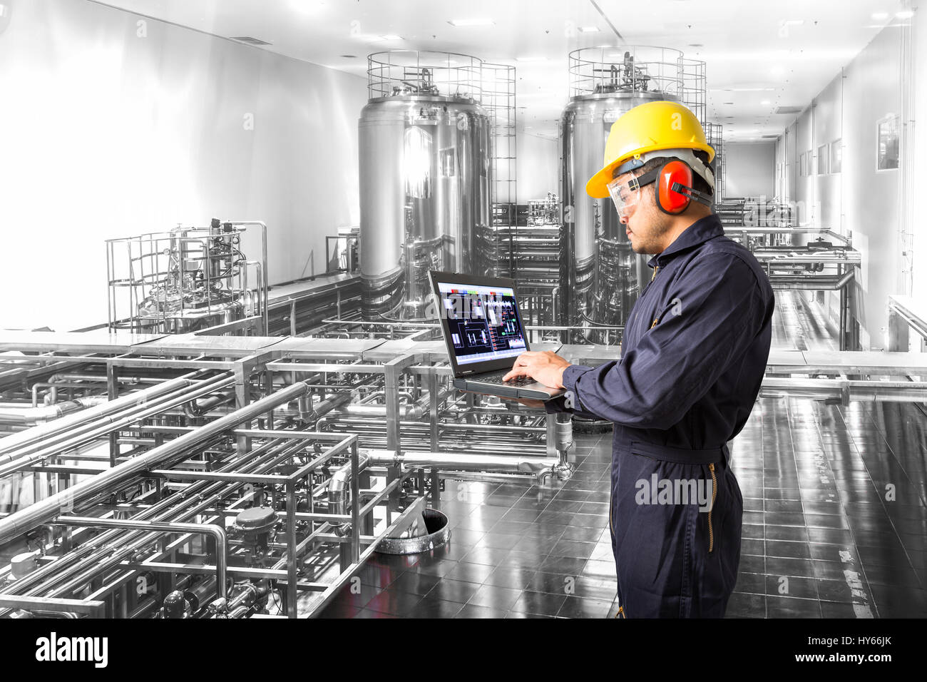 Industrial engineer checking machine status with laptop computer Stock ...