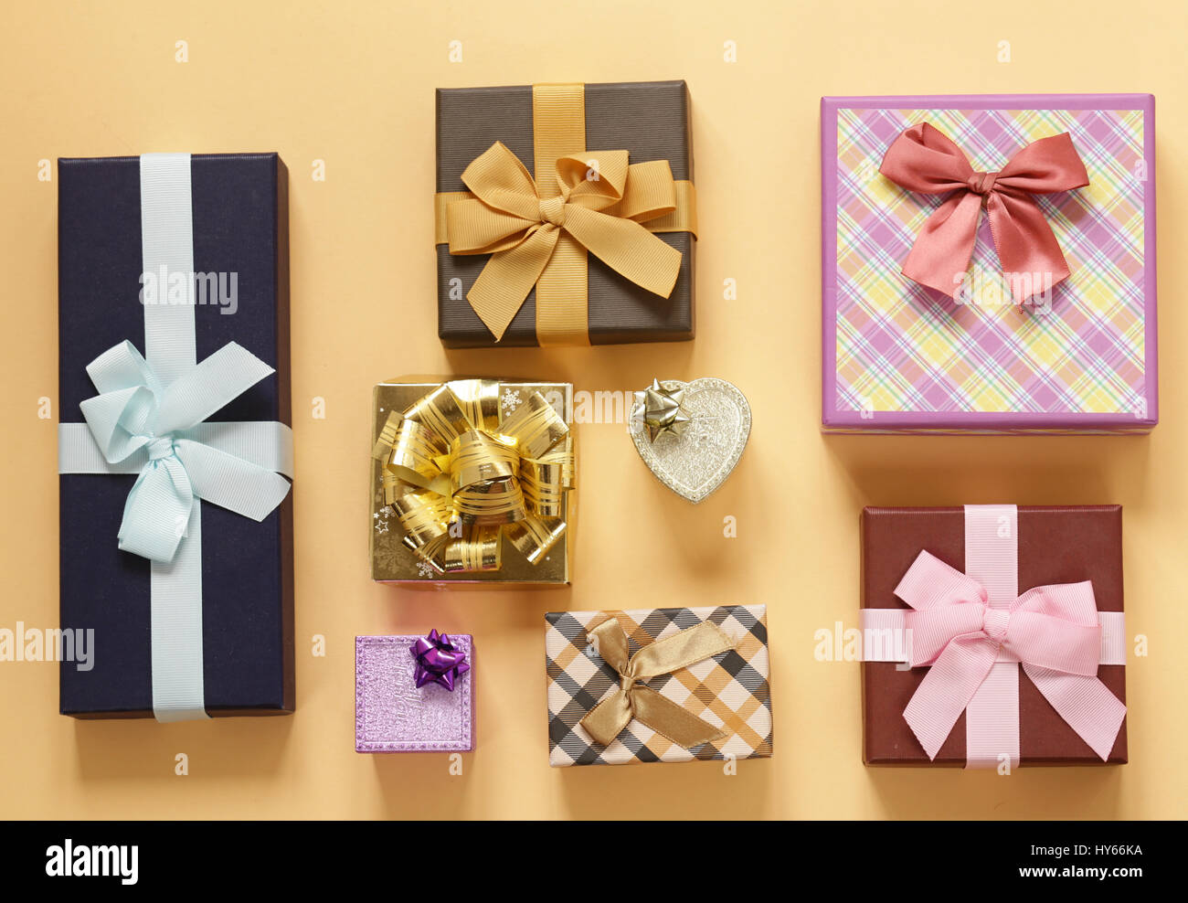 A lot of gift boxes with bows on a beige background Stock Photo - Alamy