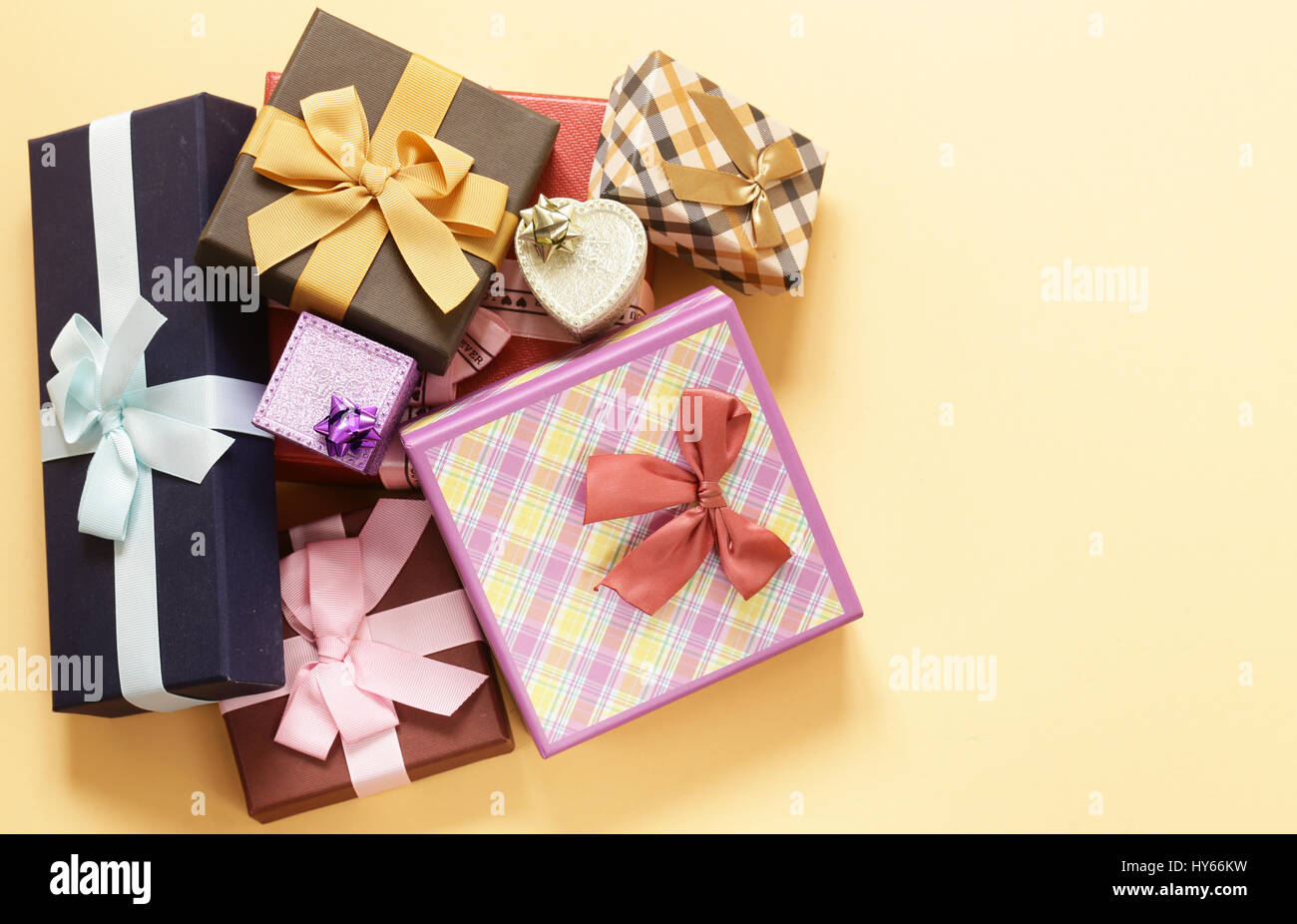 A lot of gift boxes with bows on a beige background Stock Photo - Alamy