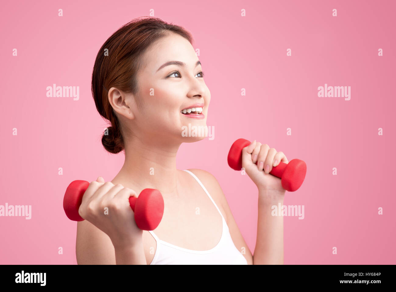 Woman Lifting Weights. Fitness woman lifting weights smiling happy on ...