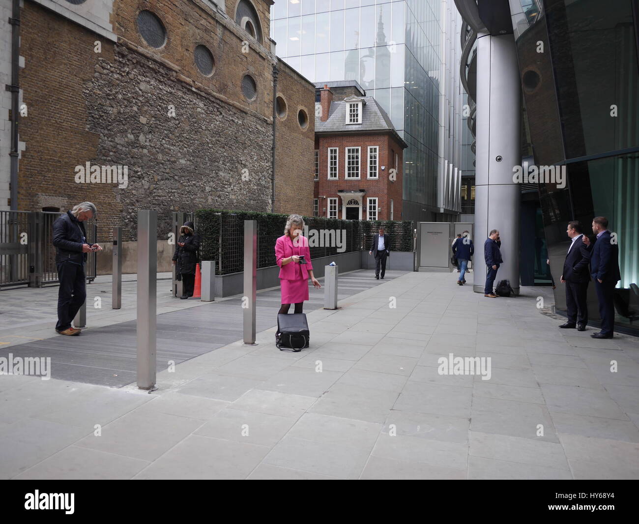 Workers smoking cigarettes outside of Walbrook Building offices of ...