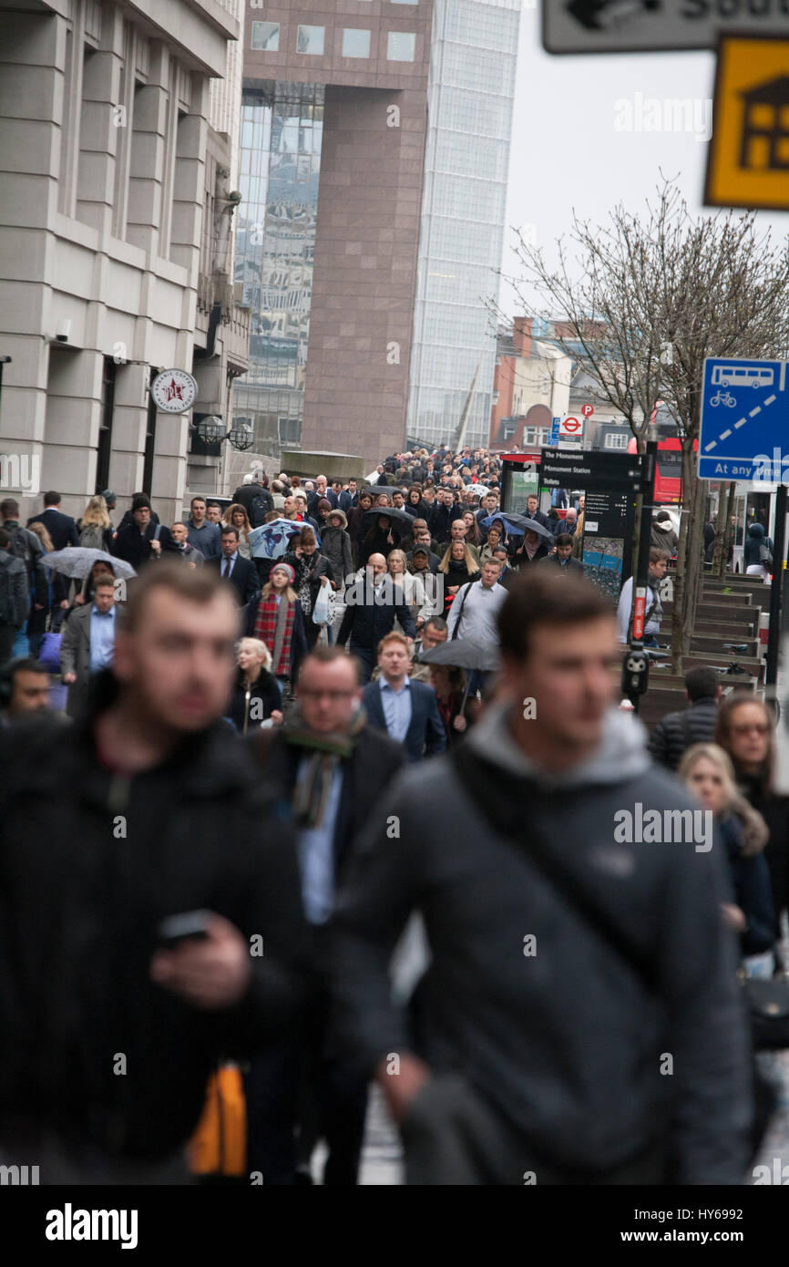 Crowds of commuters city workers, crossing London bridge during morning ...