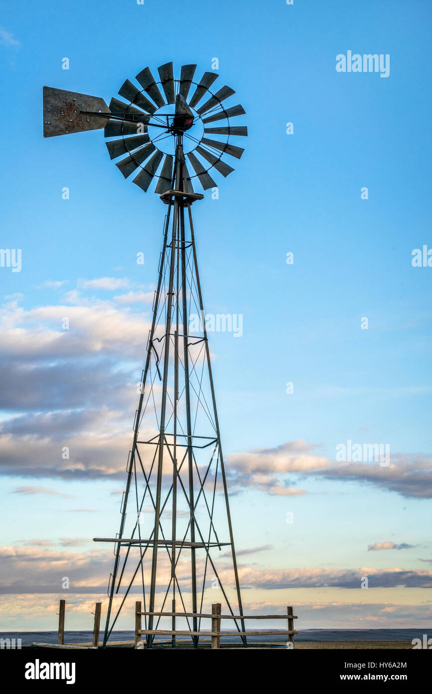 windmill with a pump and cattle water tank in shortgrass prairie ...