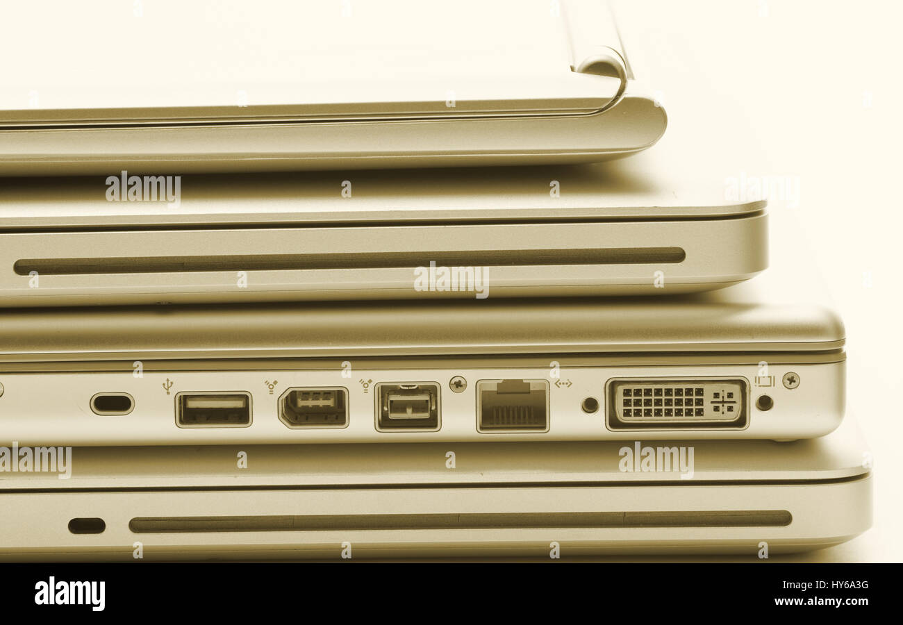 Stack of laptops with ports showing and gold filter applied Stock Photo ...
