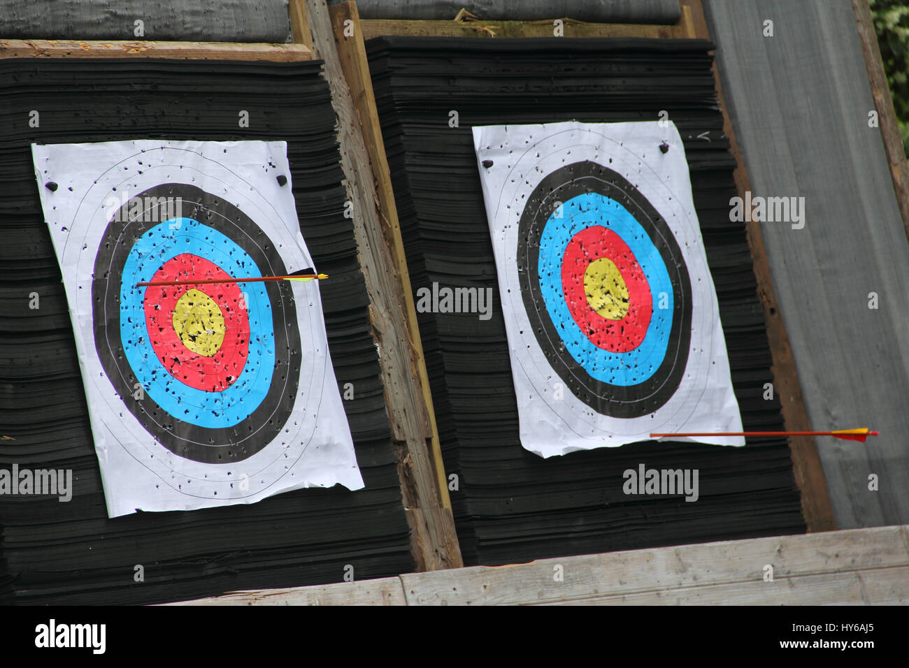 Arrows in archery target with lots of holes Stock Photo - Alamy