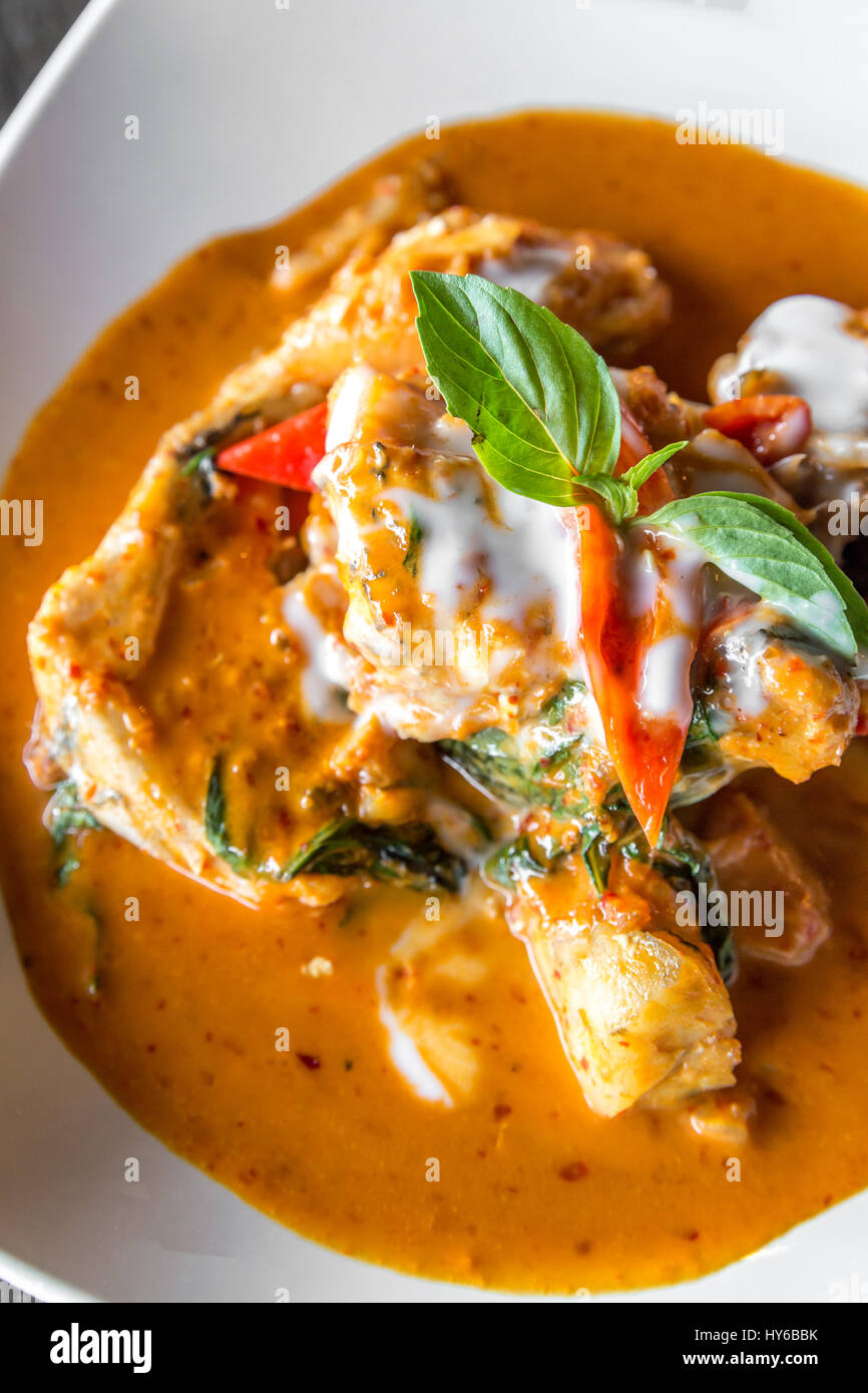 Fried grouper Fish with Red Curry Paste Chu Chee Pla Stock Photo - Alamy