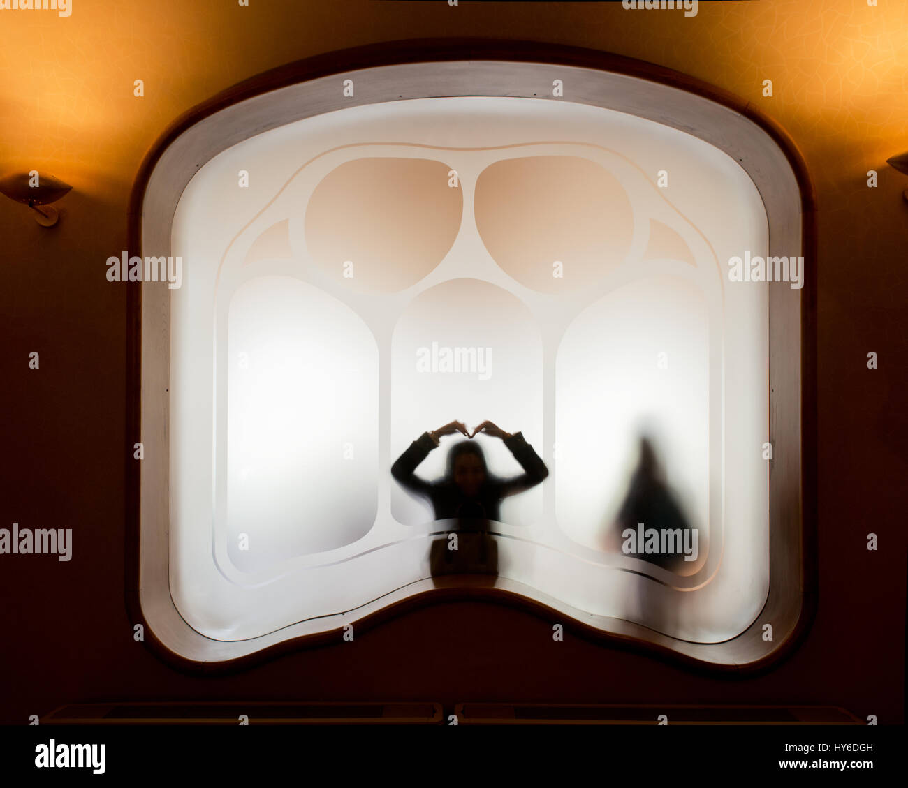 shadow of two girls in opal glass window in Casa Batlló designed by ...