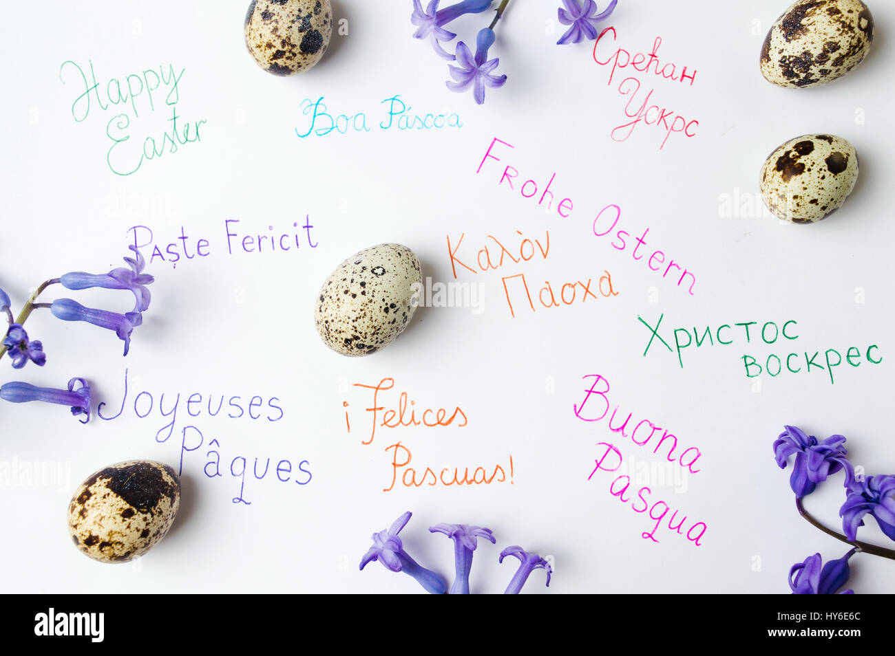 Happy Easter note in different languages and quail eggs Stock Photo - Alamy