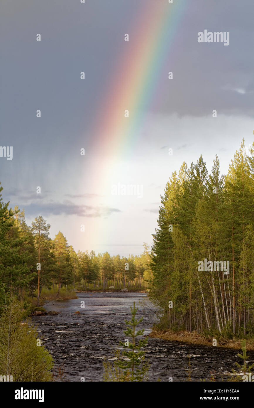 Rainbow over a river in Lappland, Sweden Stock Photo - Alamy