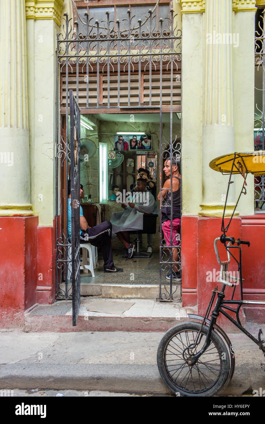 Barber shop in old Havana, Cuba, with men waiting for haircuts and ...