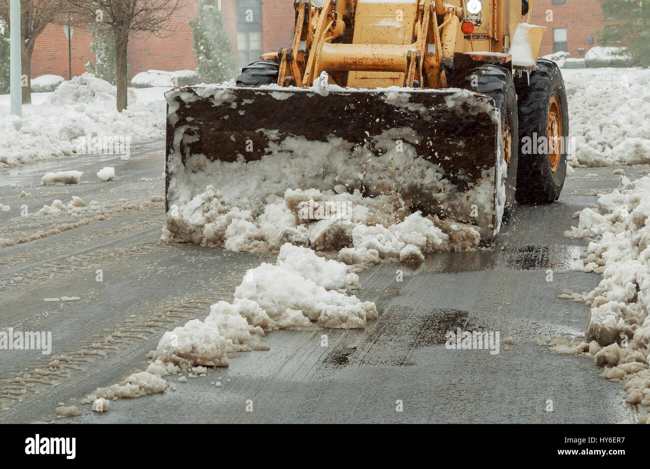 Snowplow removing snow from city road Snow-plow tractor Stock Photo - Alamy