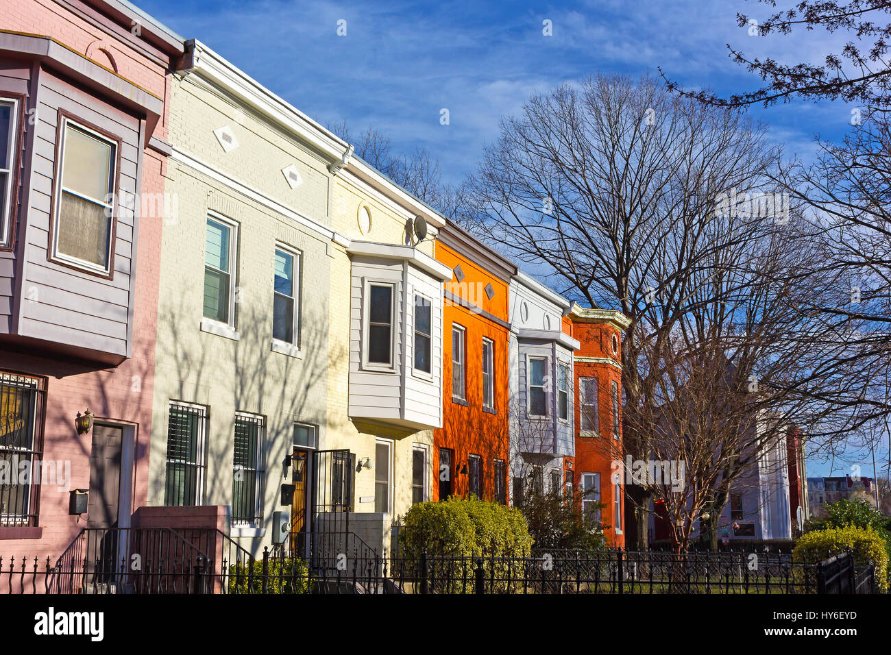 Colorful residential row houses under bright afternoon sun. Historic ...