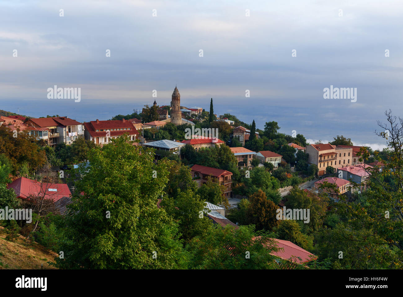 View of houses and old church in Signagi or Sighnaghi city in mountains ...