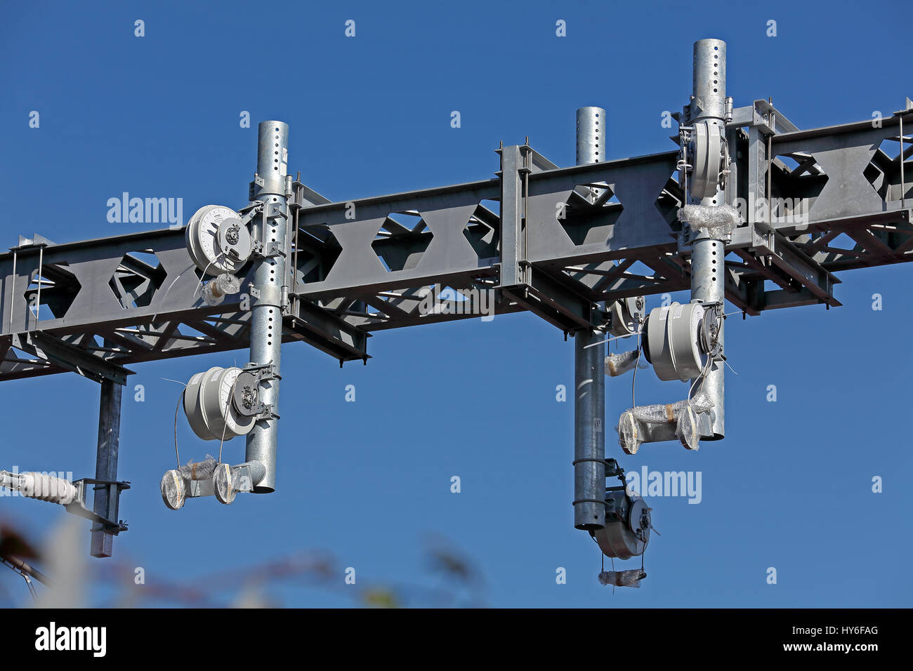 Newly installed O H L E Overhead Line Equipment on a gantry showing the ...
