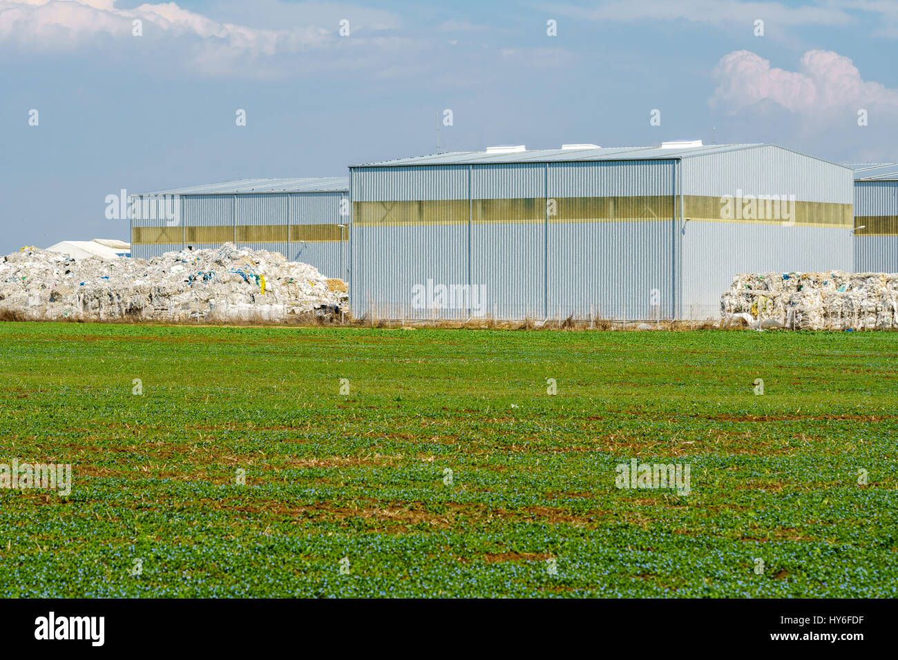 Industrial buildings with piles of garbage around them Stock Photo - Alamy