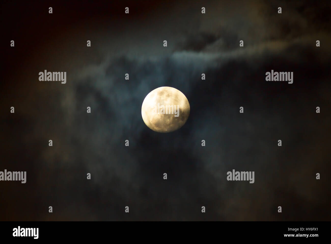 The moon covered by the clouds at cloudy night in the monsoon season ...