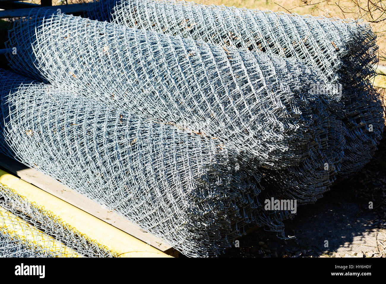 Rolls of unused metal netting stacked in small pile Stock Photo - Alamy