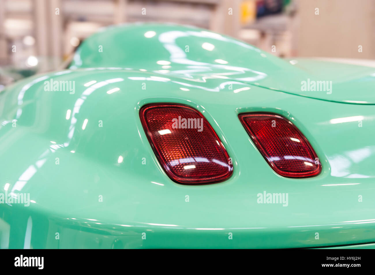 Back of a green modern sport car in the sunlight Stock Photo - Alamy