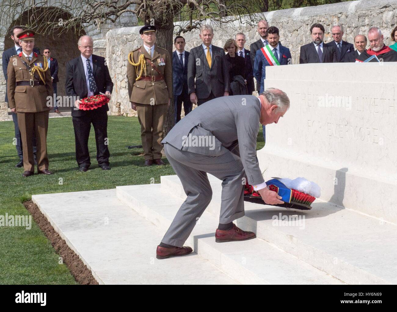 The Prince of Wales lays a wreath during a visit to the Commonwealth ...