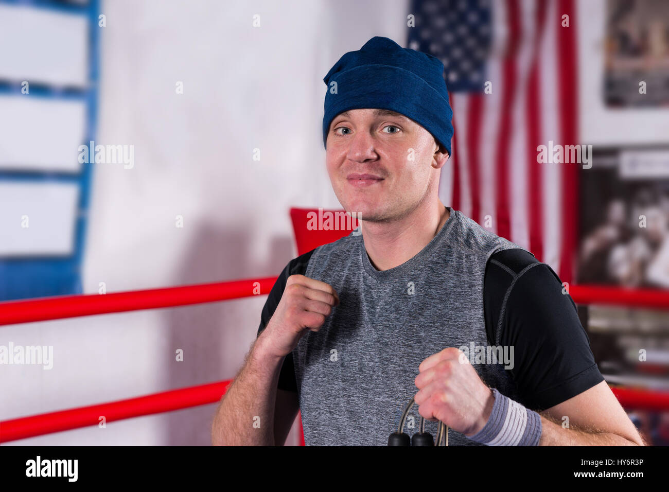 Male boxer standing in a pose clenching his fists in a regular boxing ...