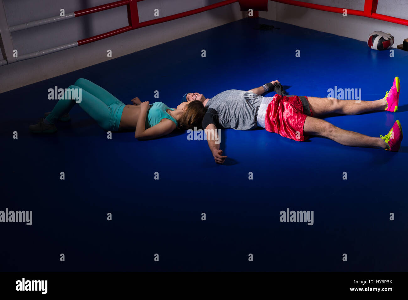 Young sporty boxing couple in sportswear lying and resting after ...