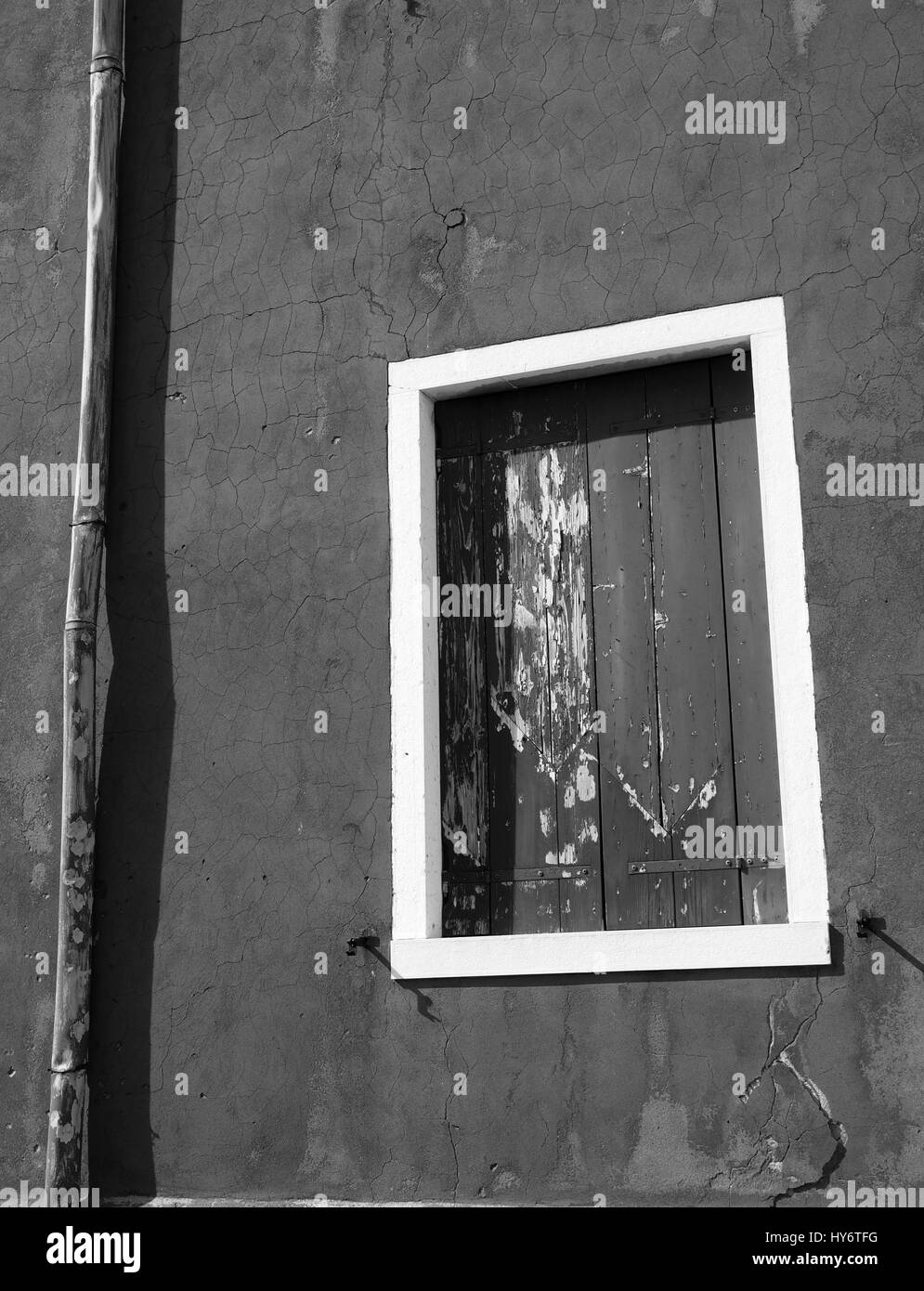 shuttered windows on an old wall with white frame Stock Photo - Alamy