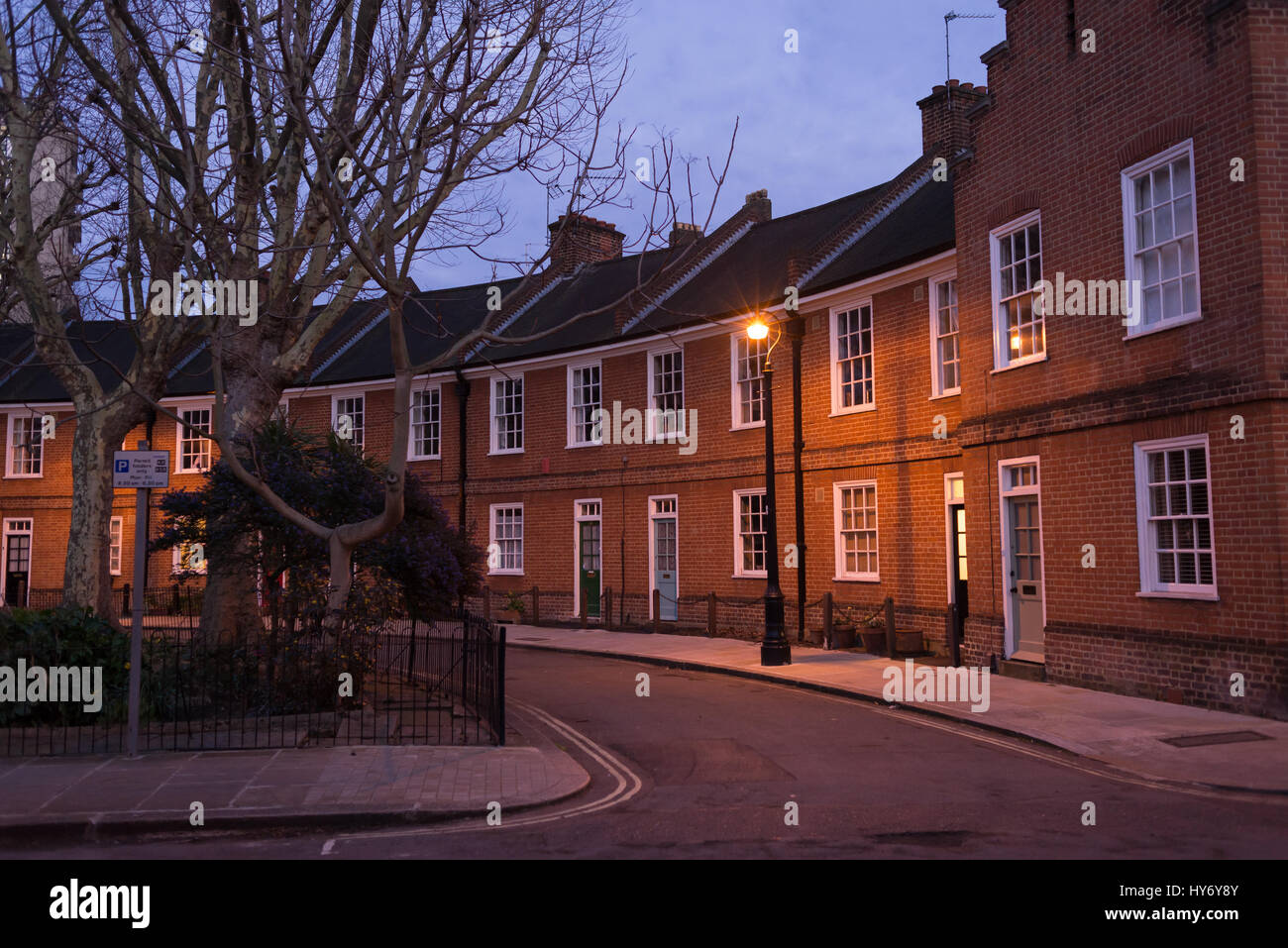 Restored Edwardian brick houses on a local road at night with street ...