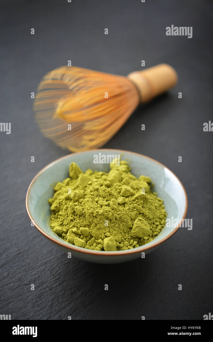 Organic Green Matcha Tea in a small cup over slate background Stock ...