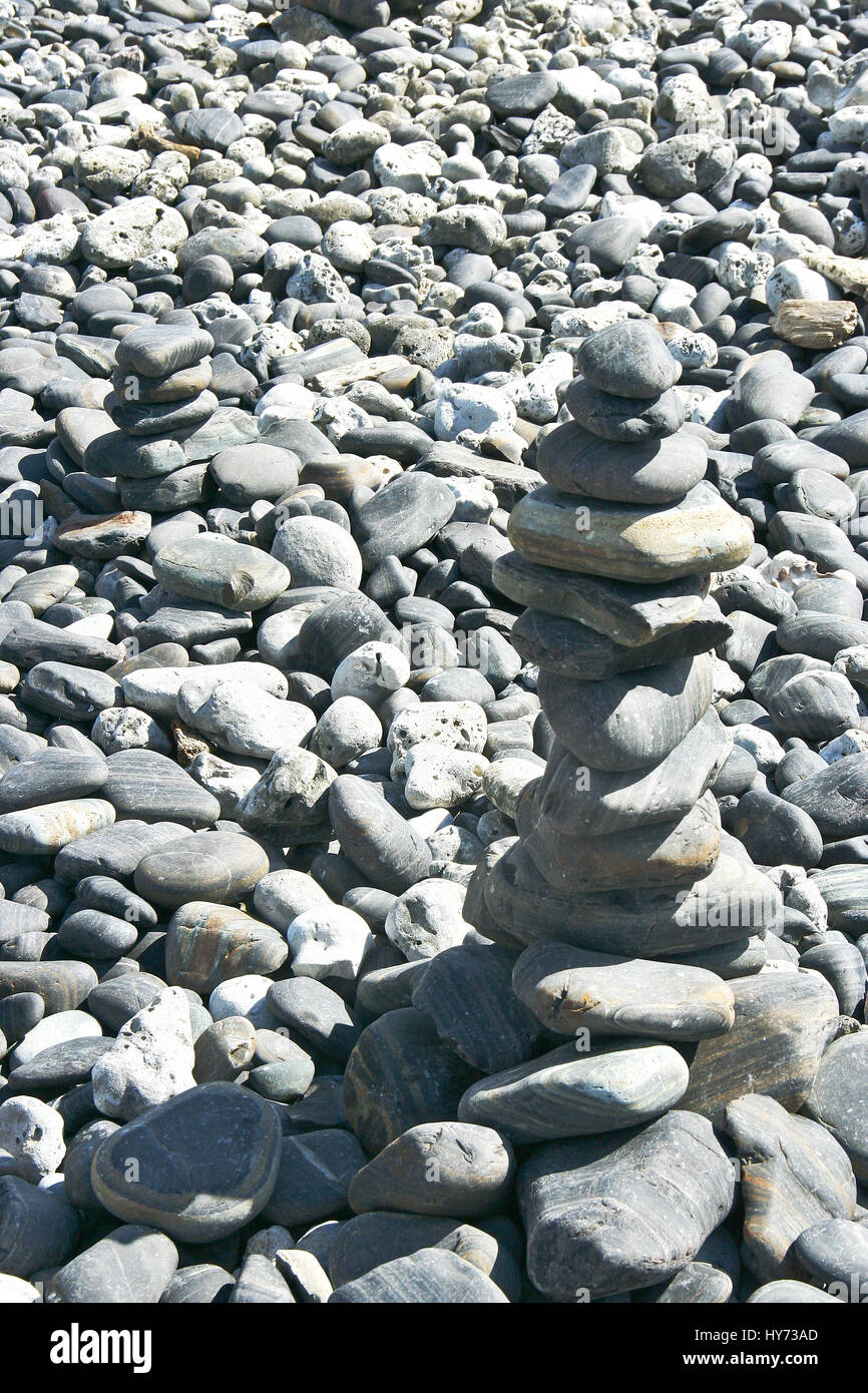Stones stacked on top of each other on a pebbly beach/ The pyramid of ...