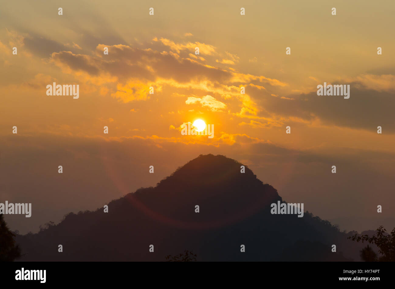 Sun with ring flare over mountain Stock Photo - Alamy