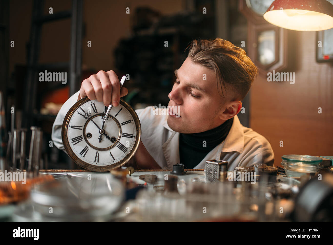 Watchmaker adjusts the mechanism of old watches in the workshop. Clock ...