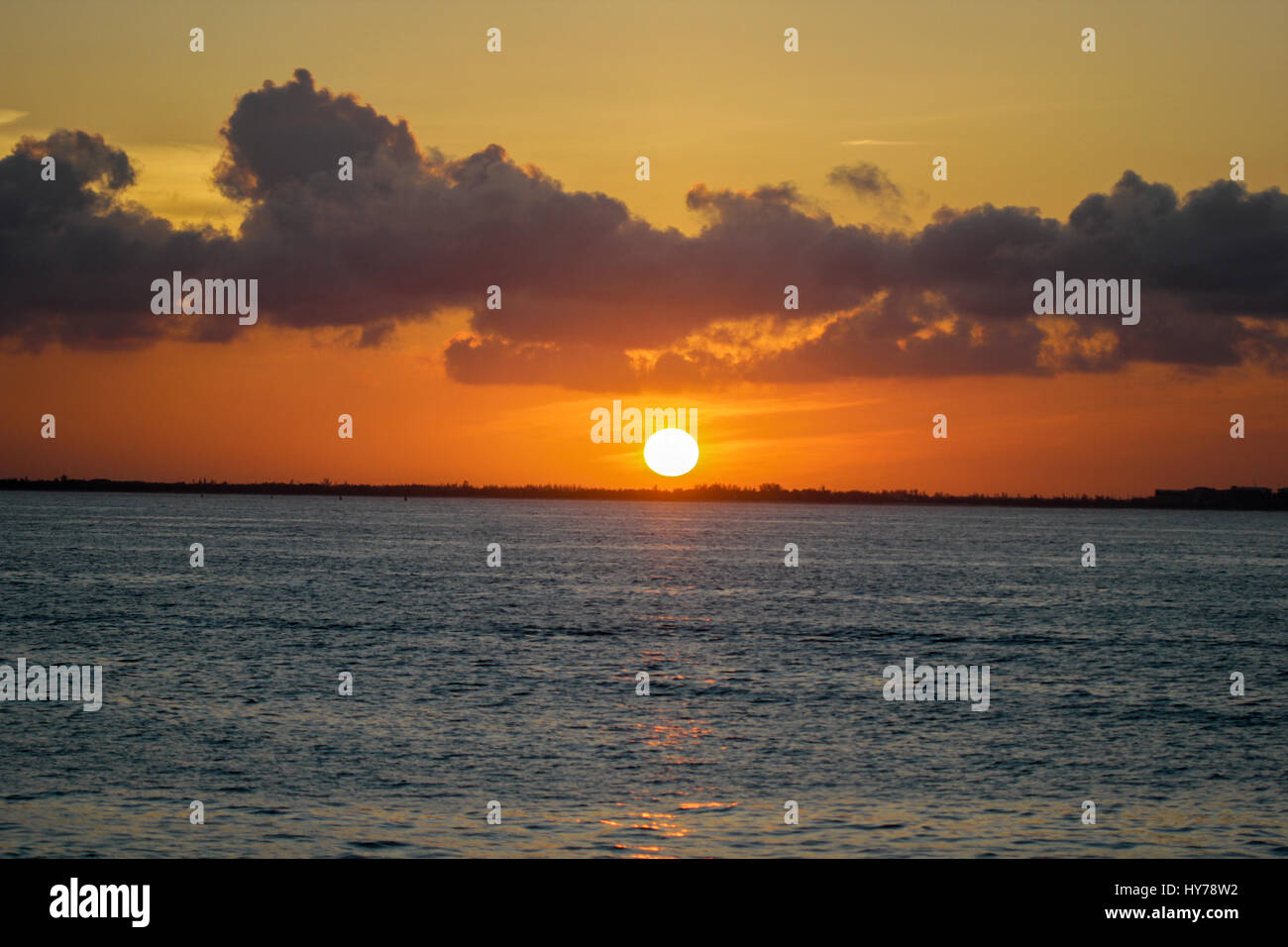 Orange sunset, sun at the sea level Stock Photo - Alamy