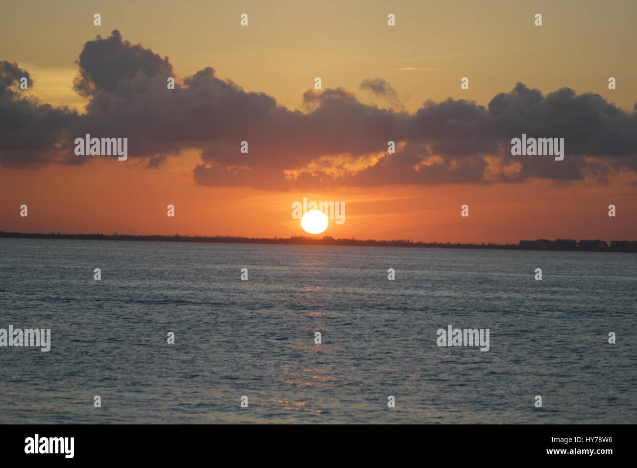Orange sunset, sun at the sea level Stock Photo - Alamy