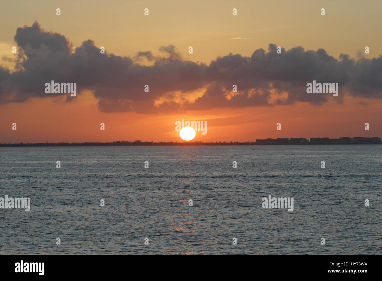 Orange sunset, sun at the sea level Stock Photo - Alamy
