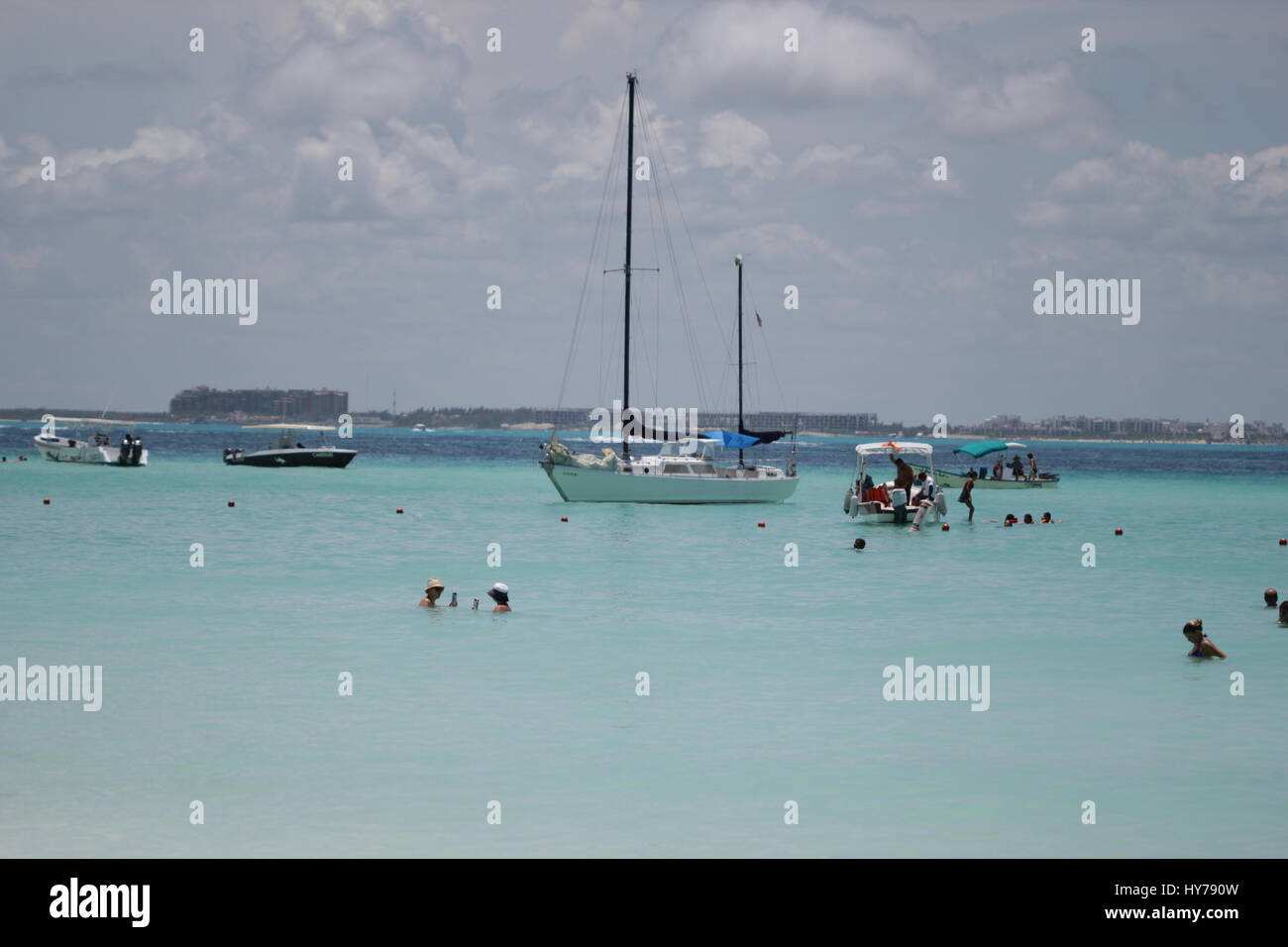 Boats and people swimming in Caribbean Sea at Isla Mujeres island ...