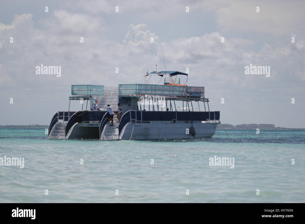 Boats and people swimming in Caribbean Sea at Isla Mujeres island ...