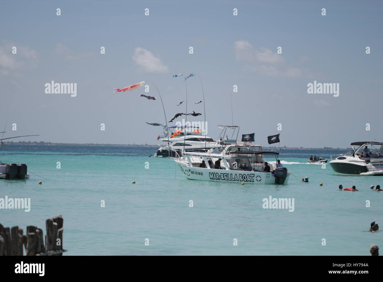 Boats and people swimming in Caribbean Sea at Isla Mujeres island ...