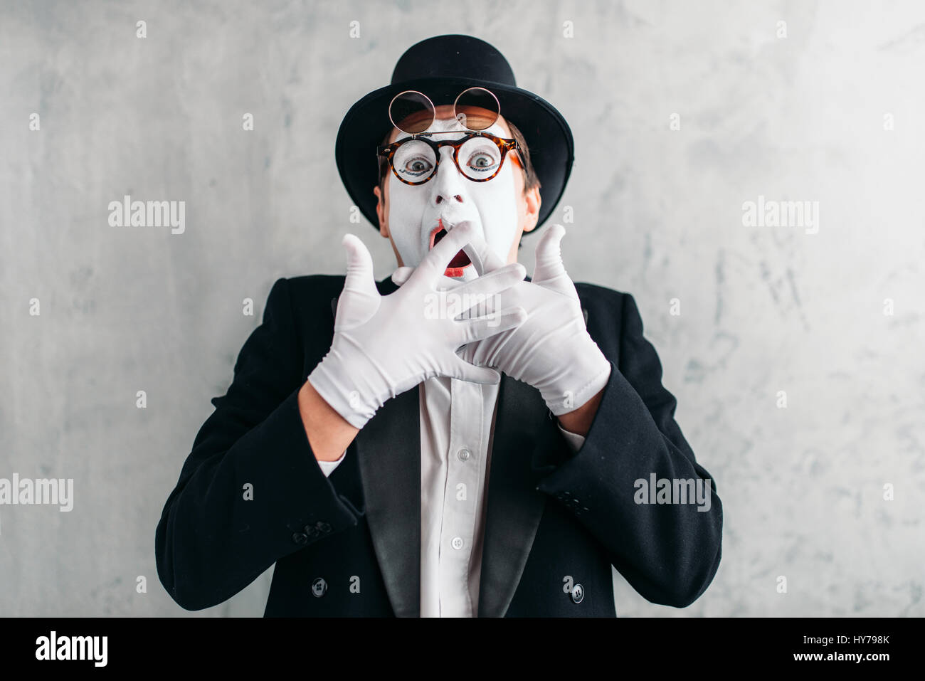 Funny mime actor with makeup mask. Pantomime in suit, gloves and hat ...